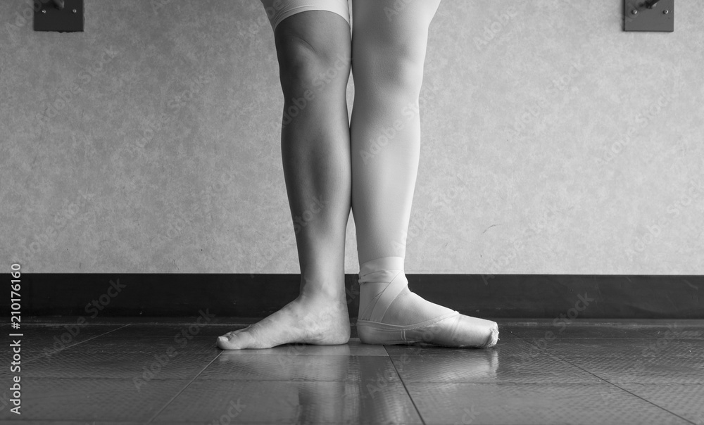 Black and white version of Two sides to a ballerina, one leg wearing ...