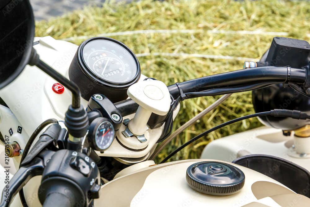 Motorcycle steering wheel with a dashboard close-up against a ...