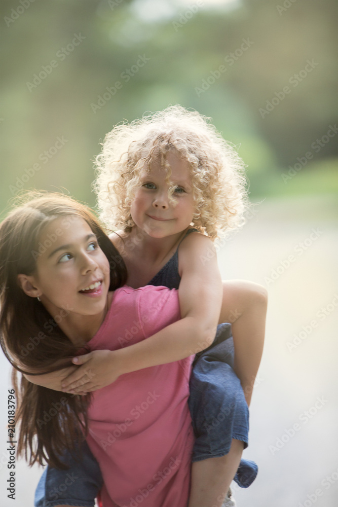 Big Sister Little Sister Playing Piggyback Stock Photo | Adobe Stock