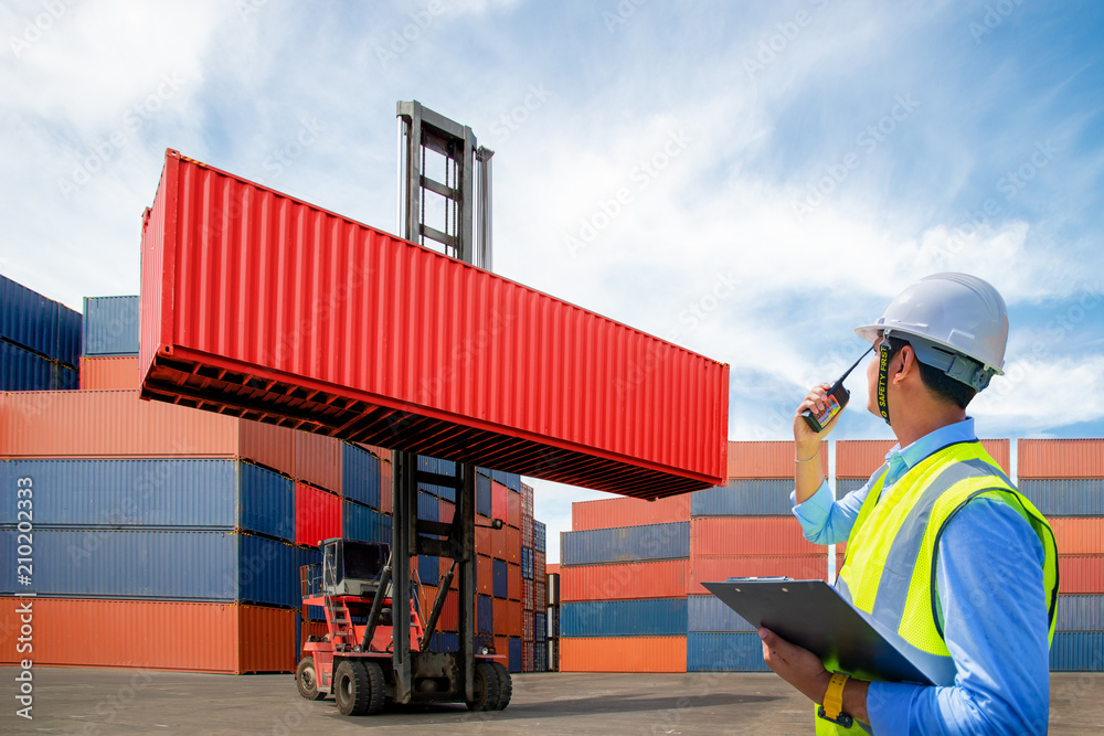 Foreman control loading containers box from cargo freight ship for ...