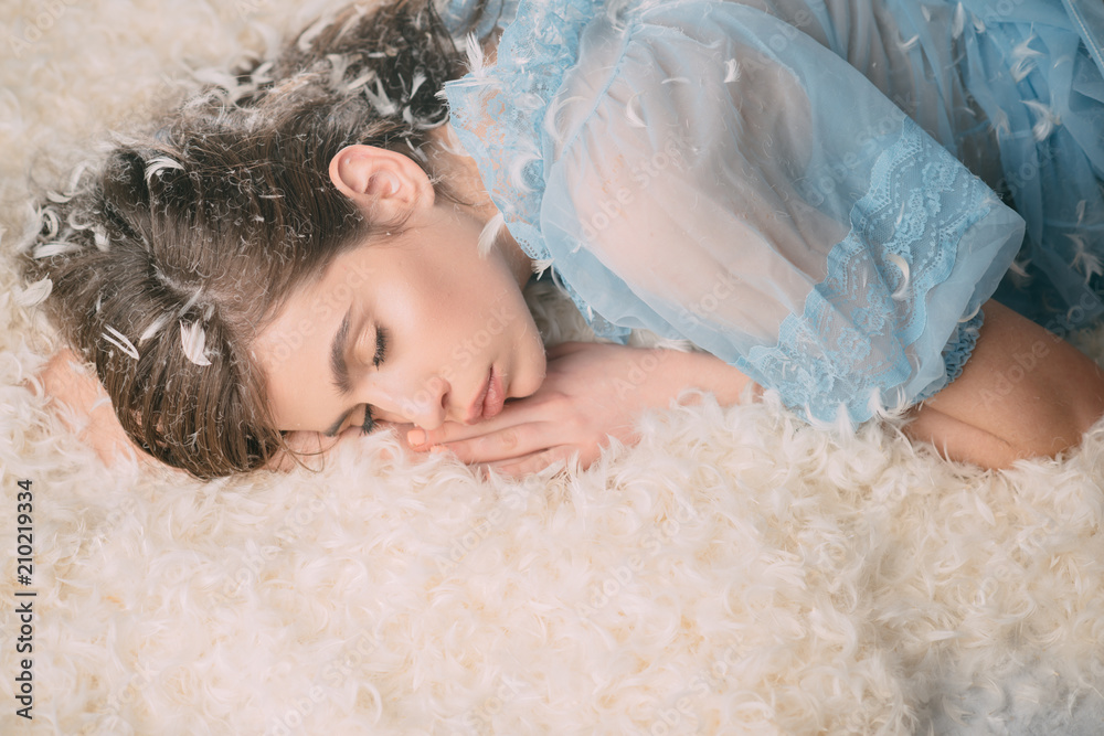 Woman with long hair in tender pajama relaxing. Girl on calm face lay ...