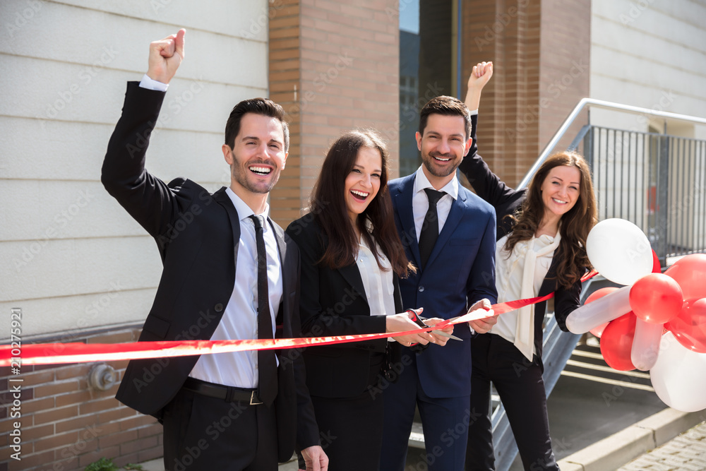 Happy Businesspeople Cutting Ribbon Stock Photo | Adobe Stock