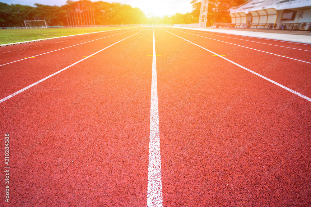 White lines of stadium and texture of running racetrack red rubber ...