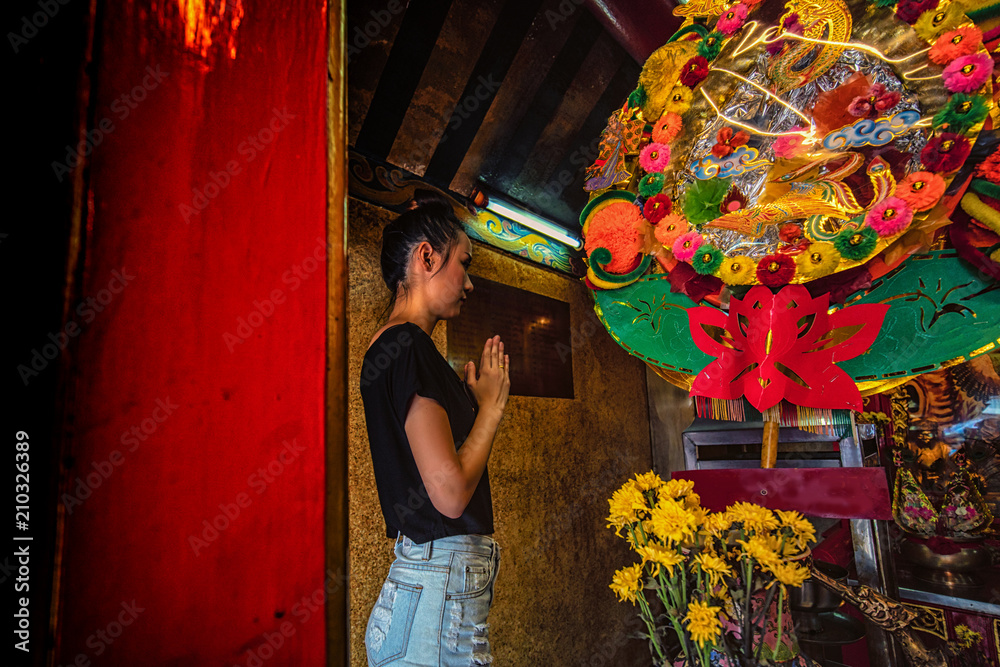 Chinese woman praying to Chinese god in the old Chines temple at ...