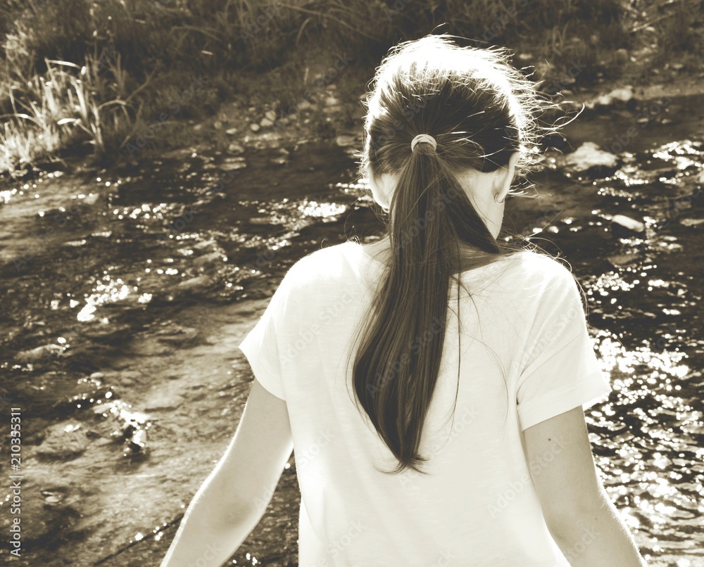 Backside portrait of a child girl with long hair, close up, sepia, copy ...