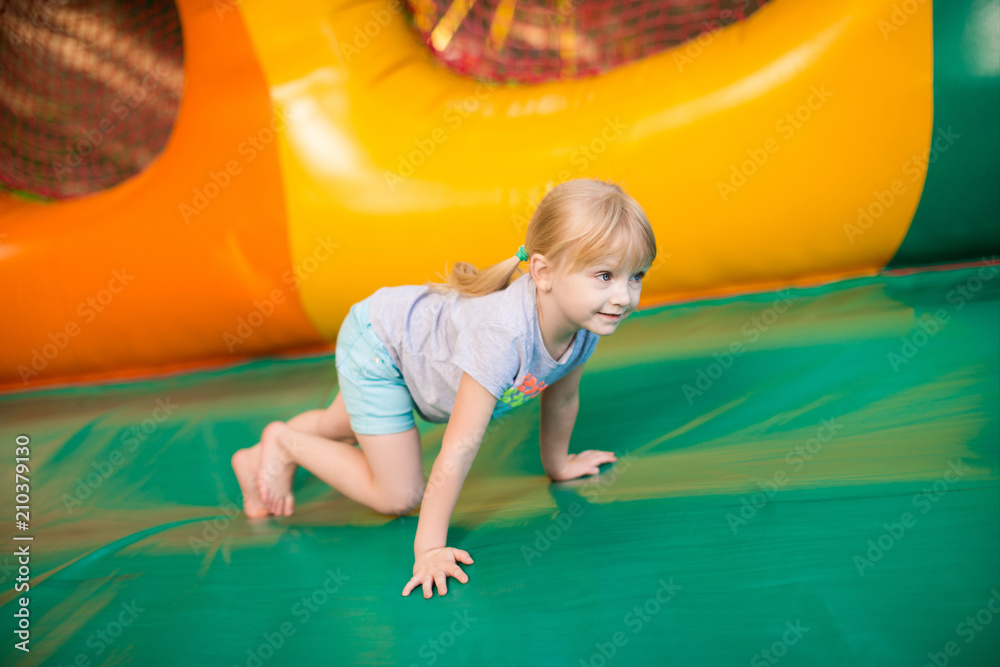 happy excited girl having fun on inflatable attraction playground ...