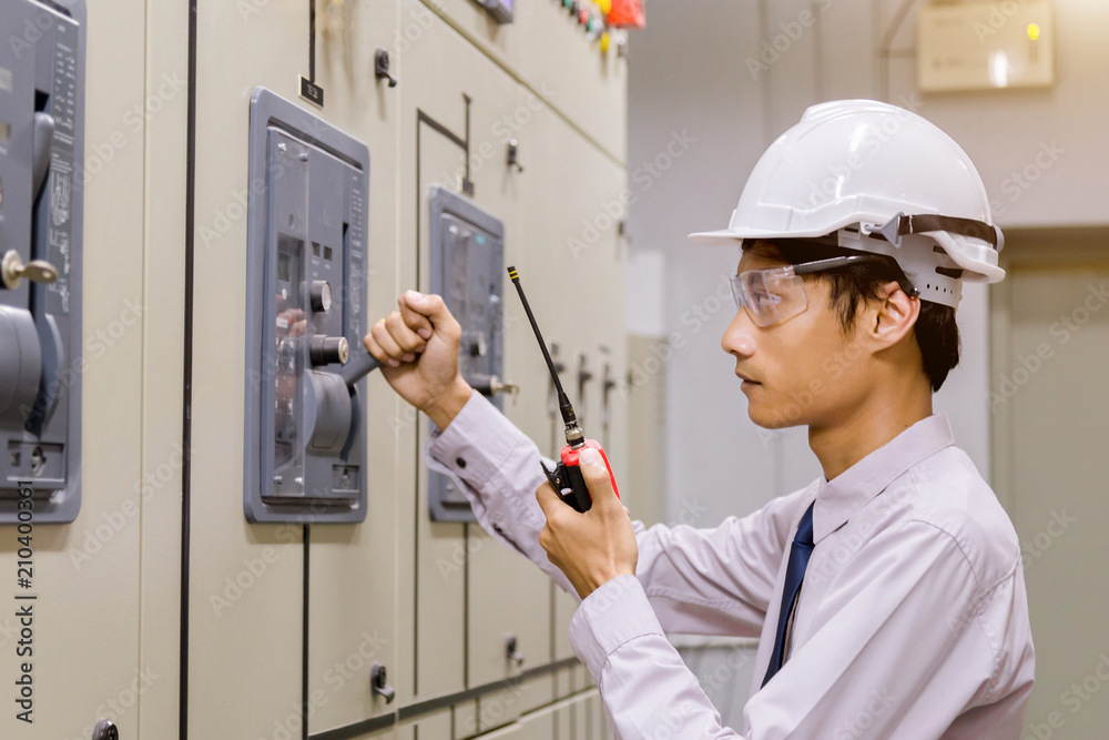 Control Room Engineer. Power Plant Control Panel. Engineer standing in ...