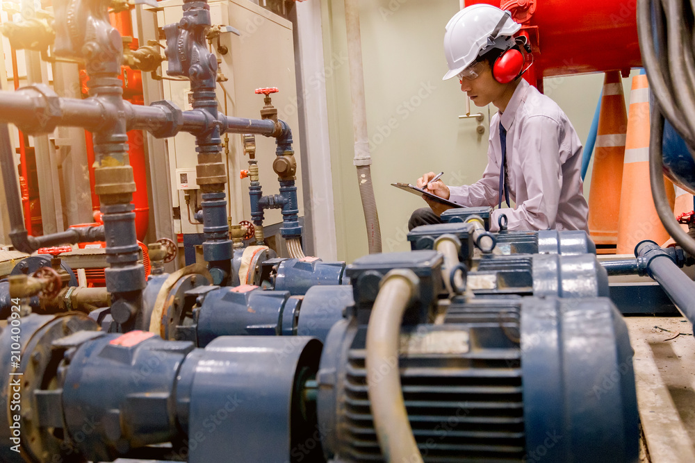 Engineer checking Condenser Water pump and pressure gauge , chiller ...