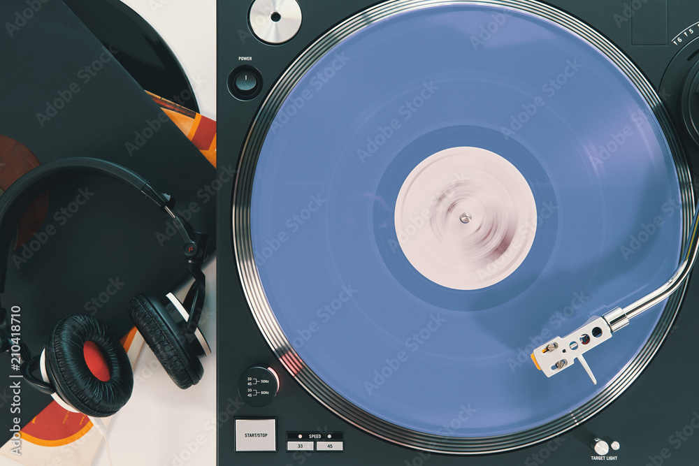 Turntable vinyl record player and black headphones on the background ...