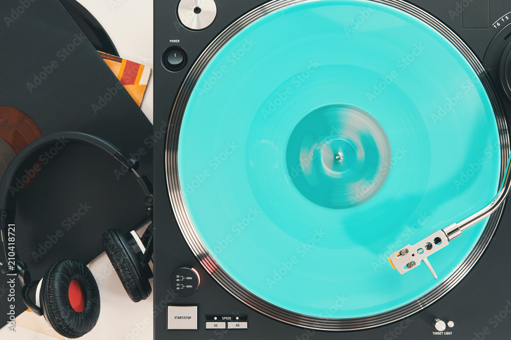 Turntable vinyl record player and black headphones on the background ...
