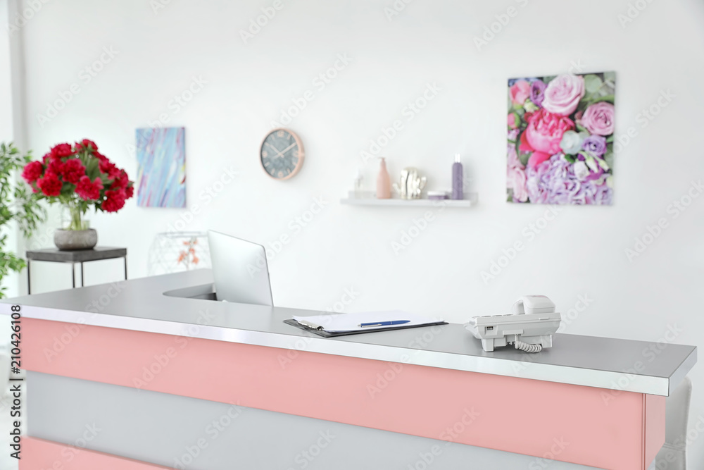 Beauty salon interior with computer on desk. Receptionist workplace ...