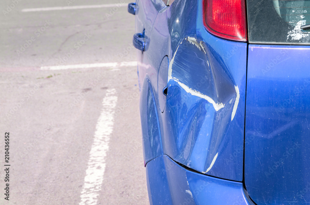 Blue scratched car with damaged paint in crash accident or parking lot ...