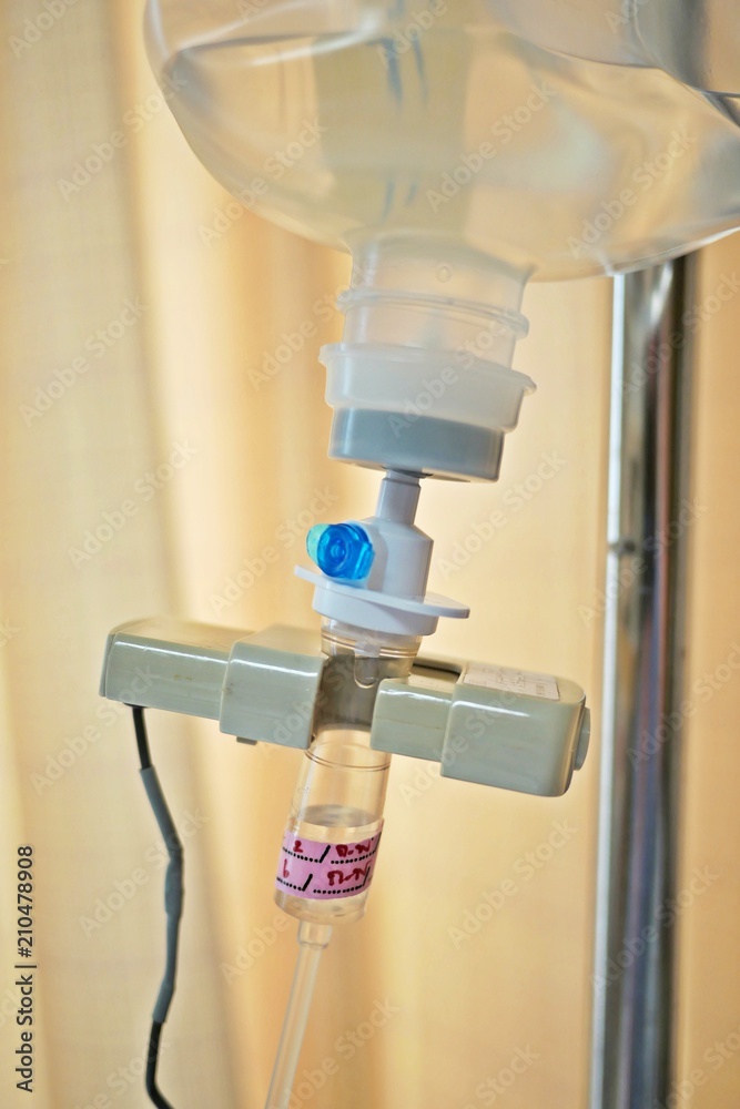 Close up IV saline solution drip for patient and infusion pump in ...