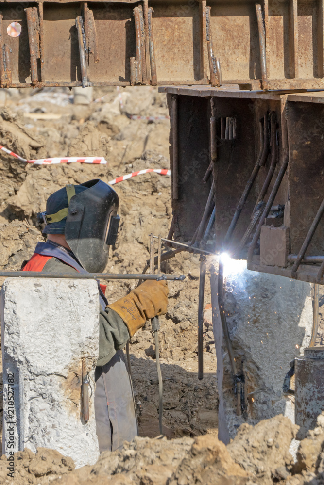 Welder at the construction site welds metal structures Stock Photo ...