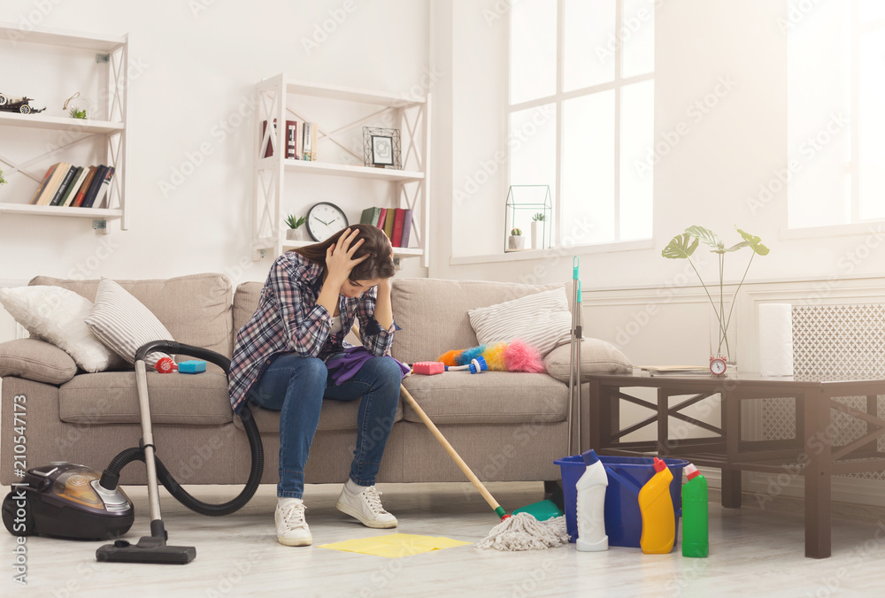 Desperate woman cleaning house with lots of tools Stock Photo | Adobe Stock