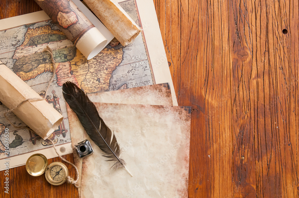 Planning a trip: quill pen, old papers and maps with vintage items ...