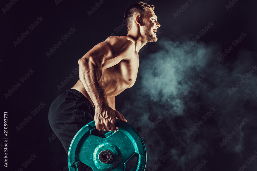 Strong athletic man pumping up muscles workout bodybuilding. muscular ...