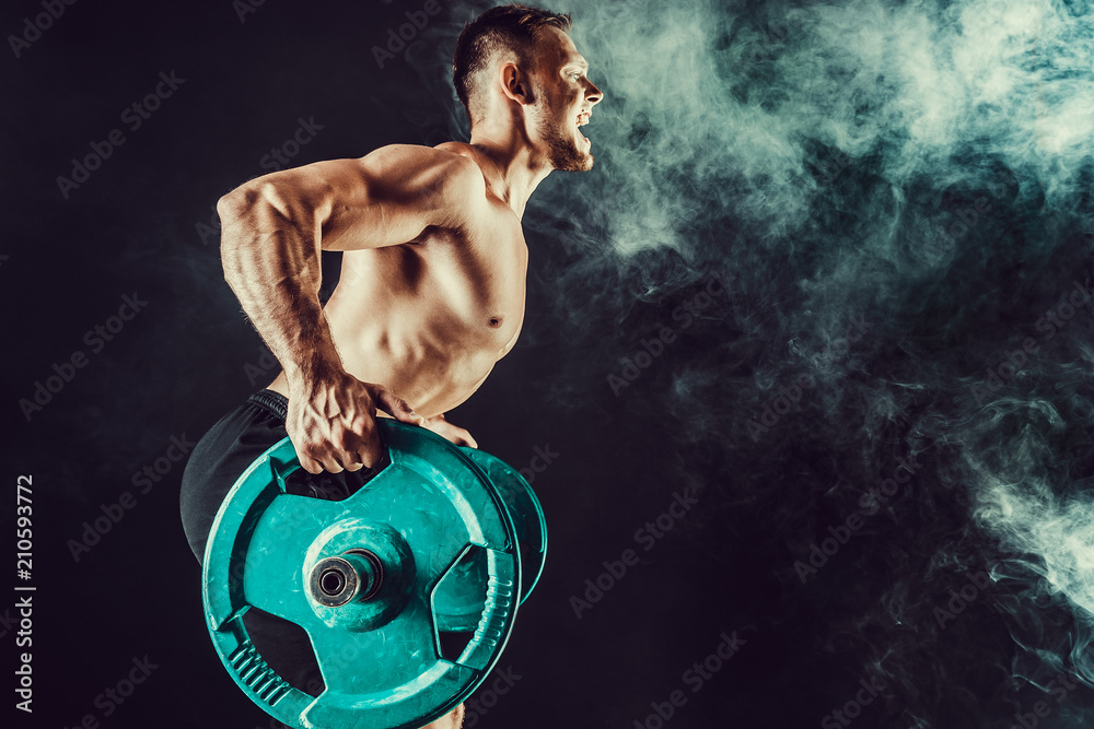 Strong athletic man pumping up muscles workout bodybuilding. muscular ...