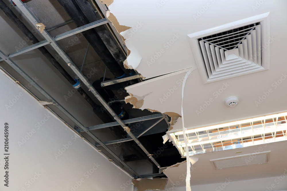 Ceiling panels damaged hole in the roof of house from drain pipes water ...