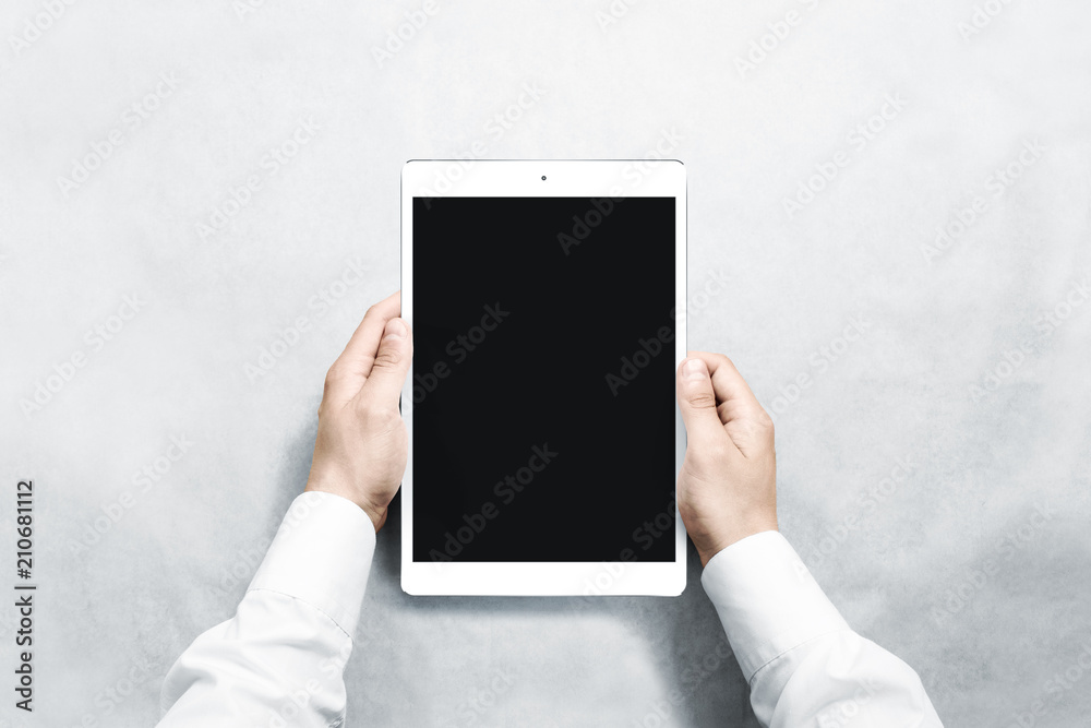 Hands holding blank vertical tablet mock up, new portable pc screen ...