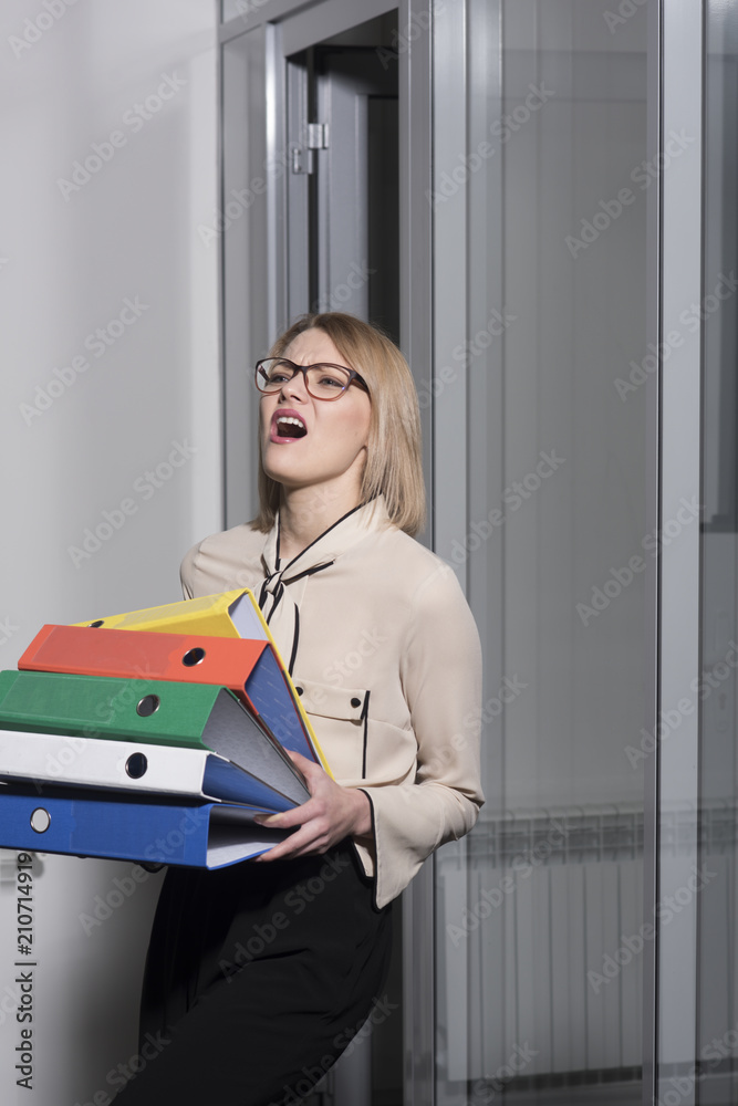 Tired woman hold file folders in office. Business woman hard work with ...