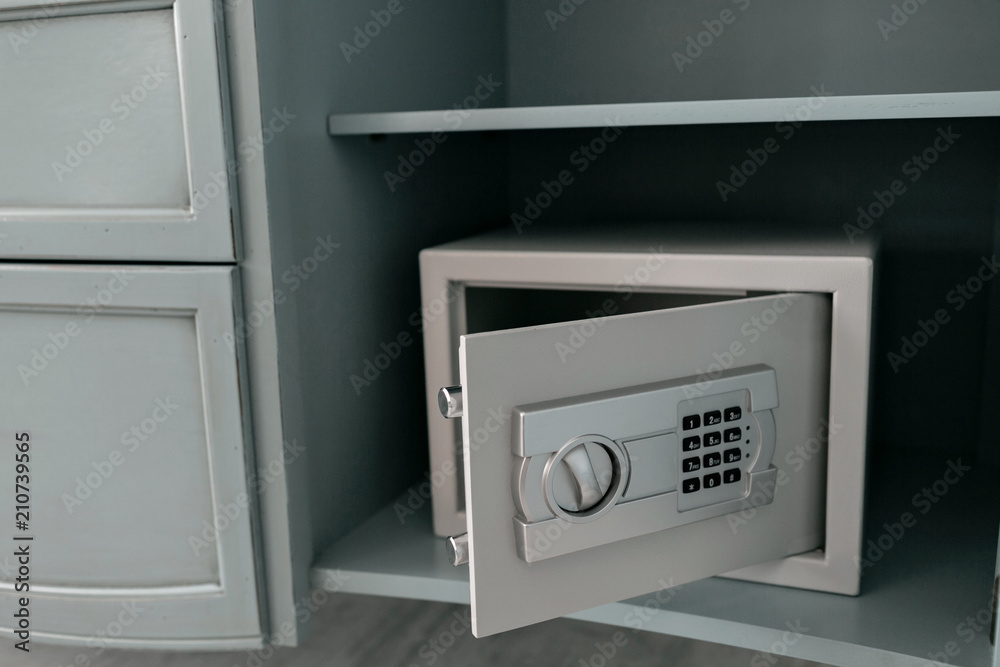 Open safe in a wealthy house. Safety box in hotel room. Concept safe ...