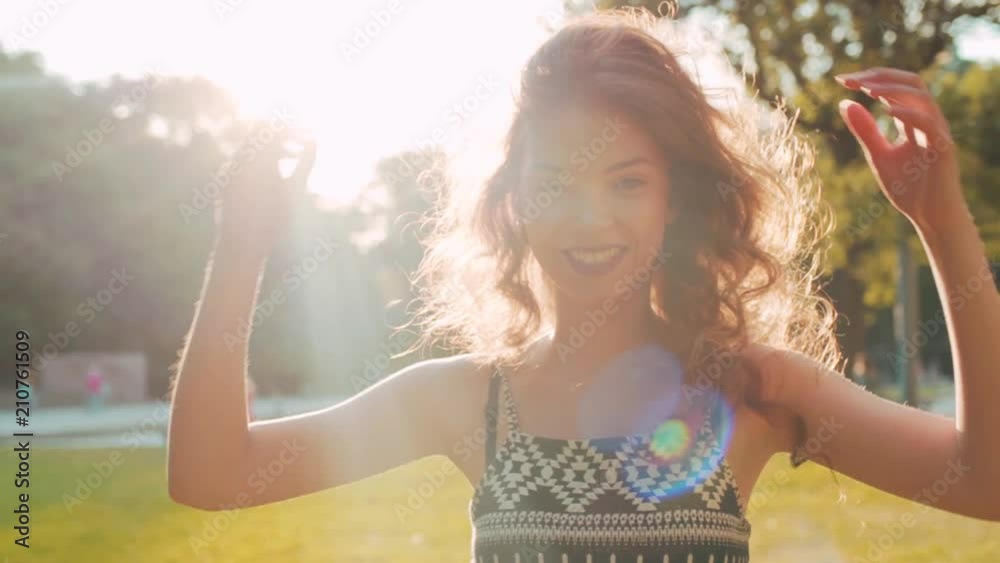Back view of gorgeous blue-eyed young woman in a light summer dress ...