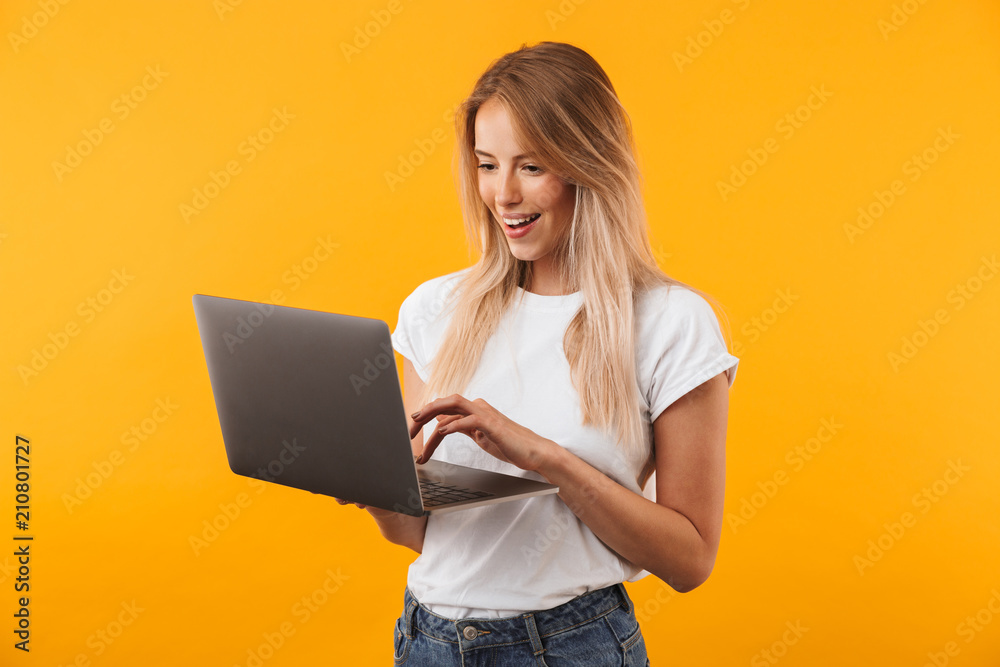 Portrait of a happy young blonde girl using laptop computer Stock Photo ...
