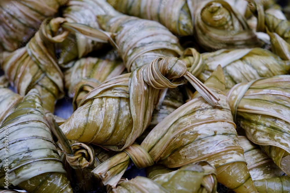 Ketupat daun palas or rice dumpling where glutinous rice is wrapped in ...