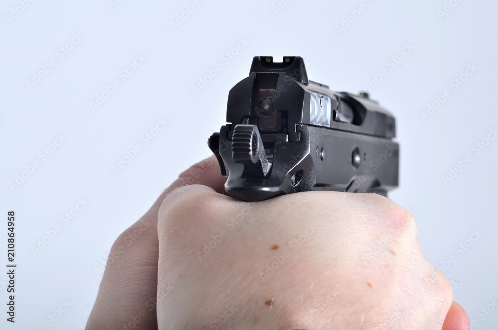 Hand aiming with pistol - view through the pistol sight Stock Photo ...