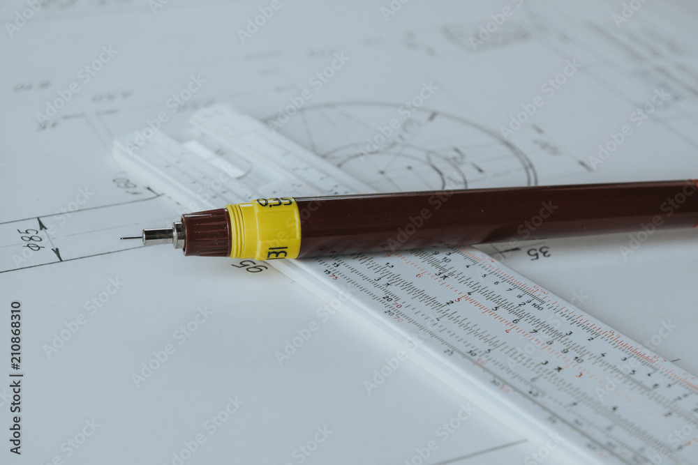 Technical pen (rapidograph) on slide rule and technical drawing ...