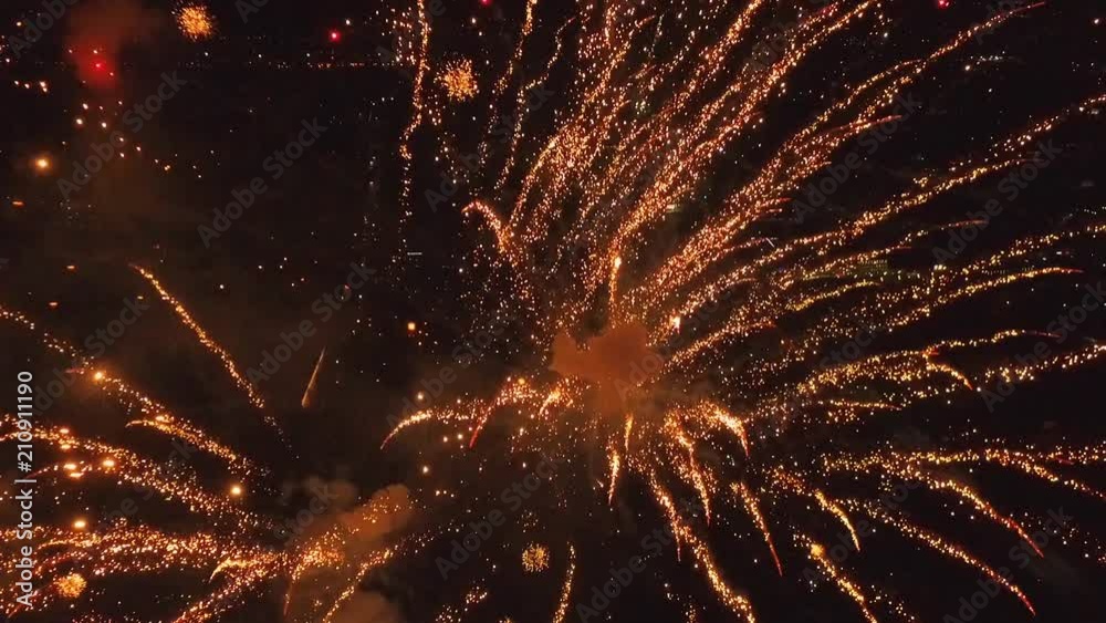 Bright firework explosion in the night sky. Fireworks salute with the ...