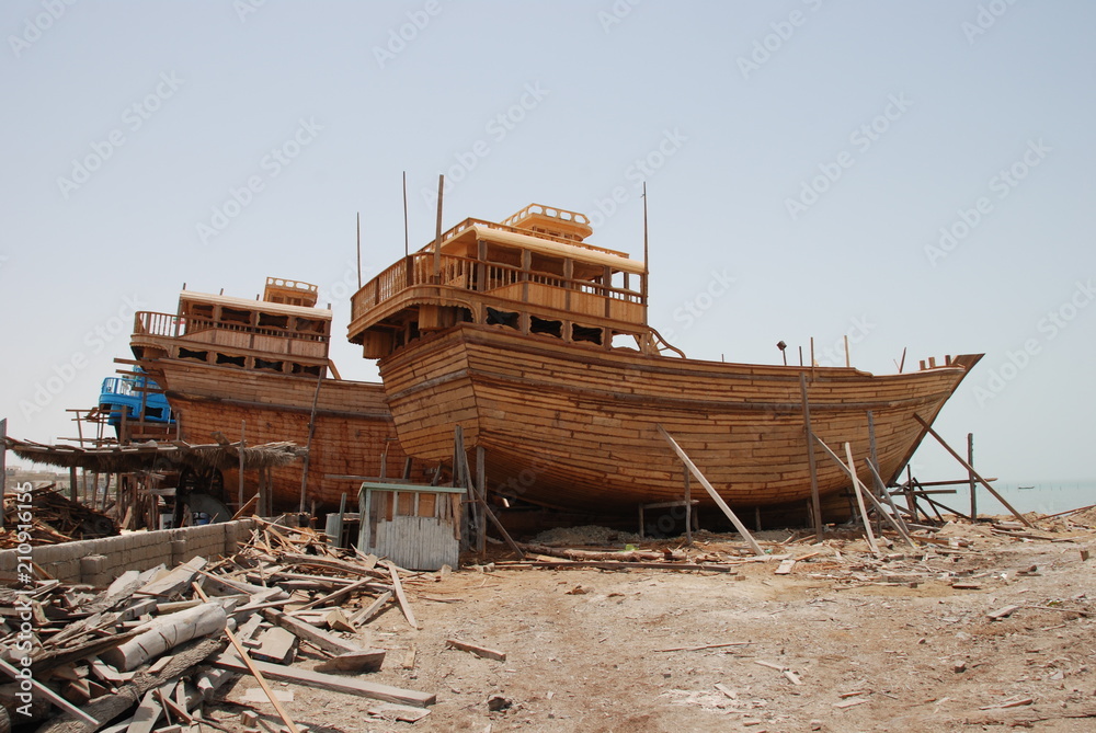 Construction of traditional Dhow boats in a shipyard on Iranian Qeshm ...