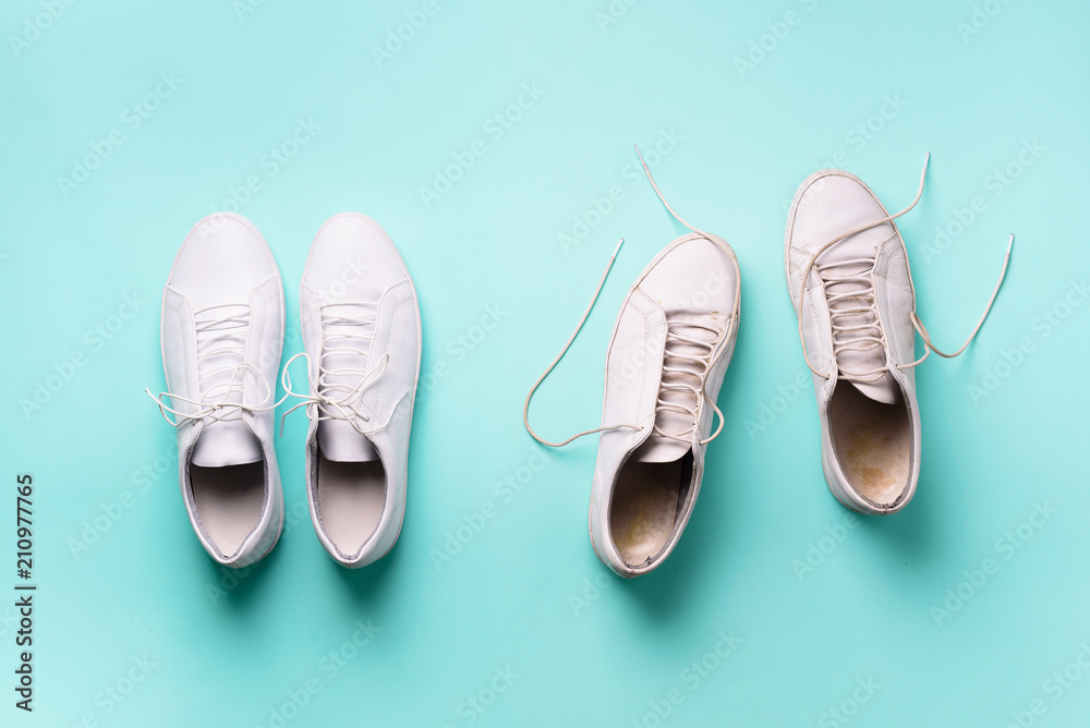 Old dirty sneakers vs new white sneakers on blue background. Trendy ...