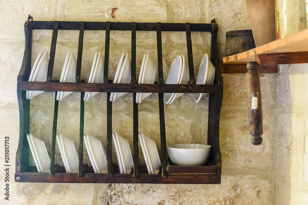 Bowls hanging on a wall rack in a traditional Maltese kitchen Stock ...