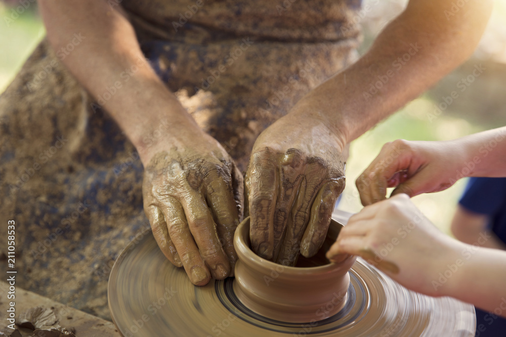 Child in Clay Pottery Making Class. Potter sculpting clay pot on a ...
