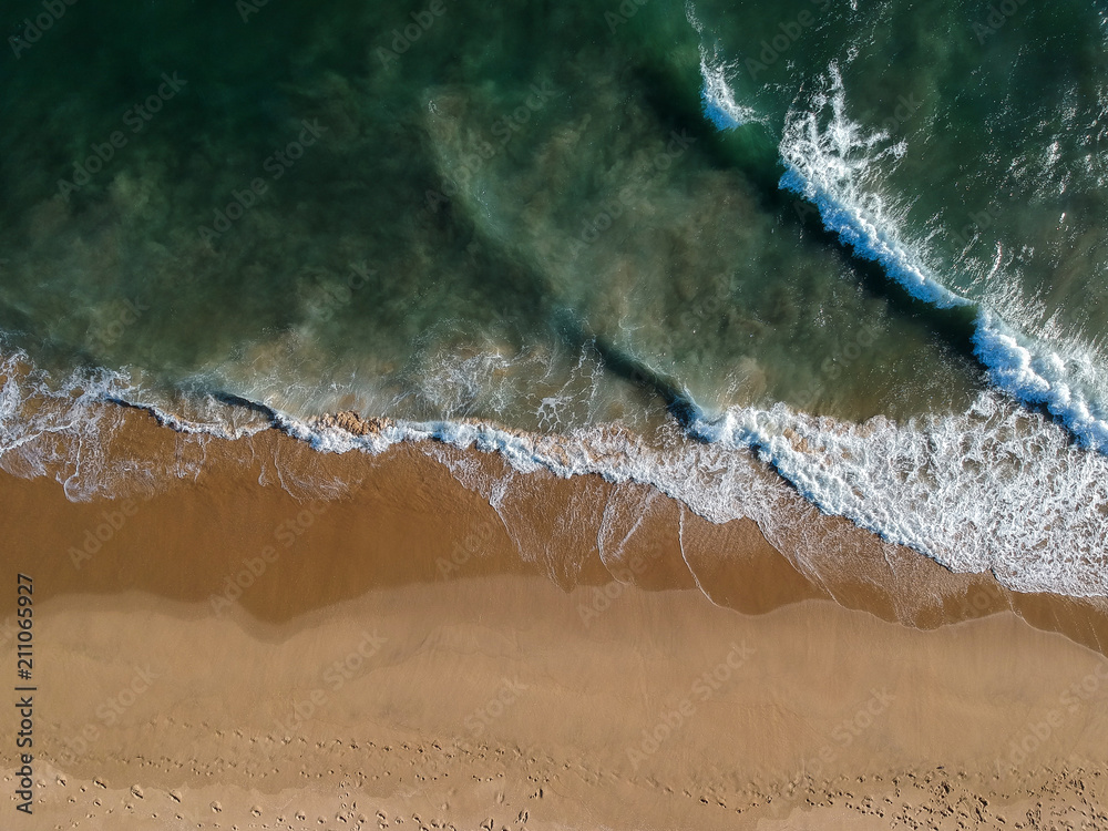 Breaking waves and sandy waters Stock Photo | Adobe Stock