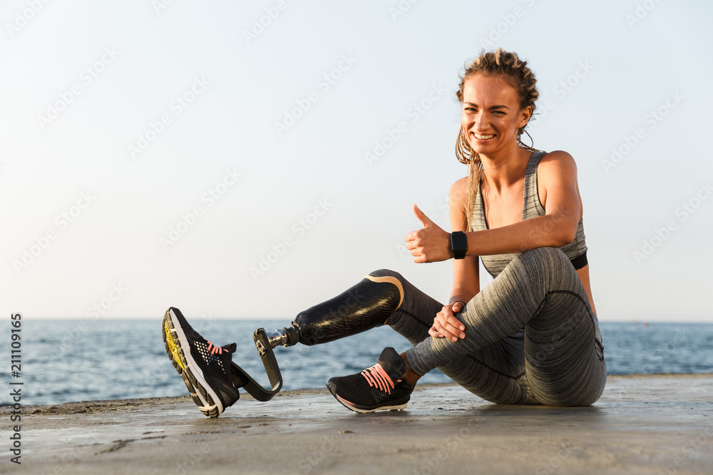Smiling disabled athlete woman with prosthetic leg Stock Photo | Adobe ...