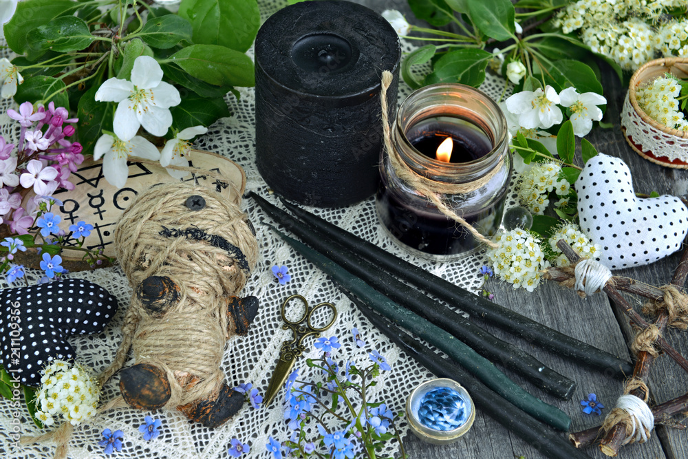 Voodoo doll, black candles, flowers and mysterious objects. Occult ...