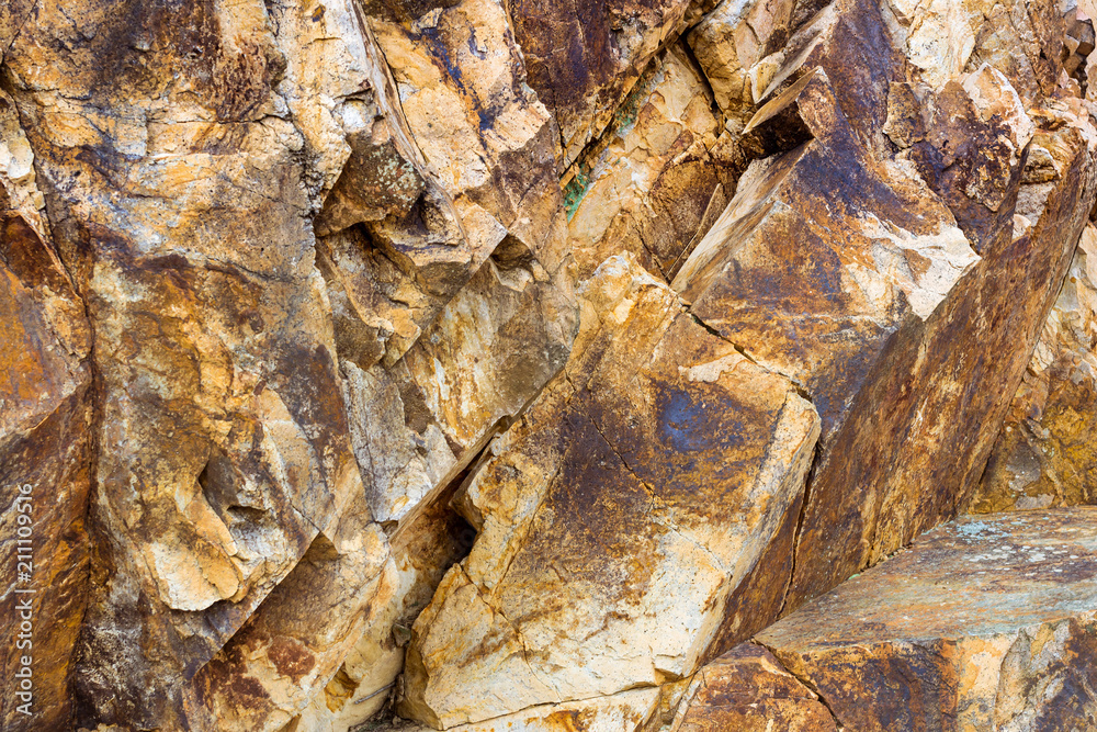 Brown stone texture. Rock formation with cracks and protrusions ...