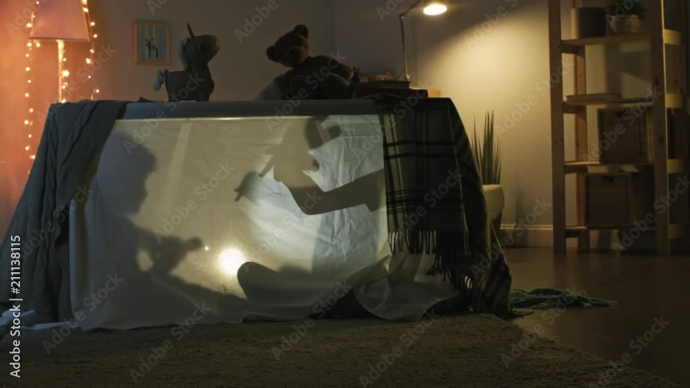 Silhouettes of two unrecognizable little children of elementary school ...