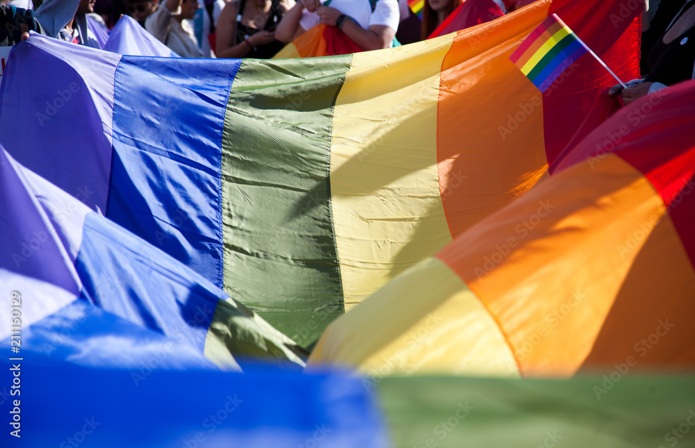 people holding giant rainbow flag at pride parade - LGBT symbol Stock ...