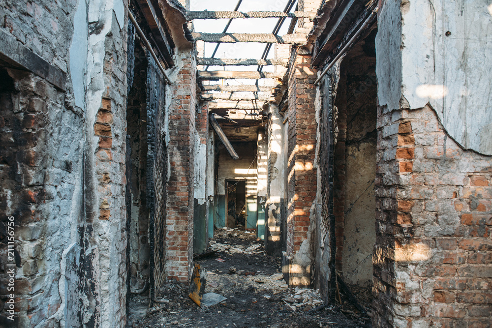 Ruins of burned brick house after fire disaster accident. Corridor ...