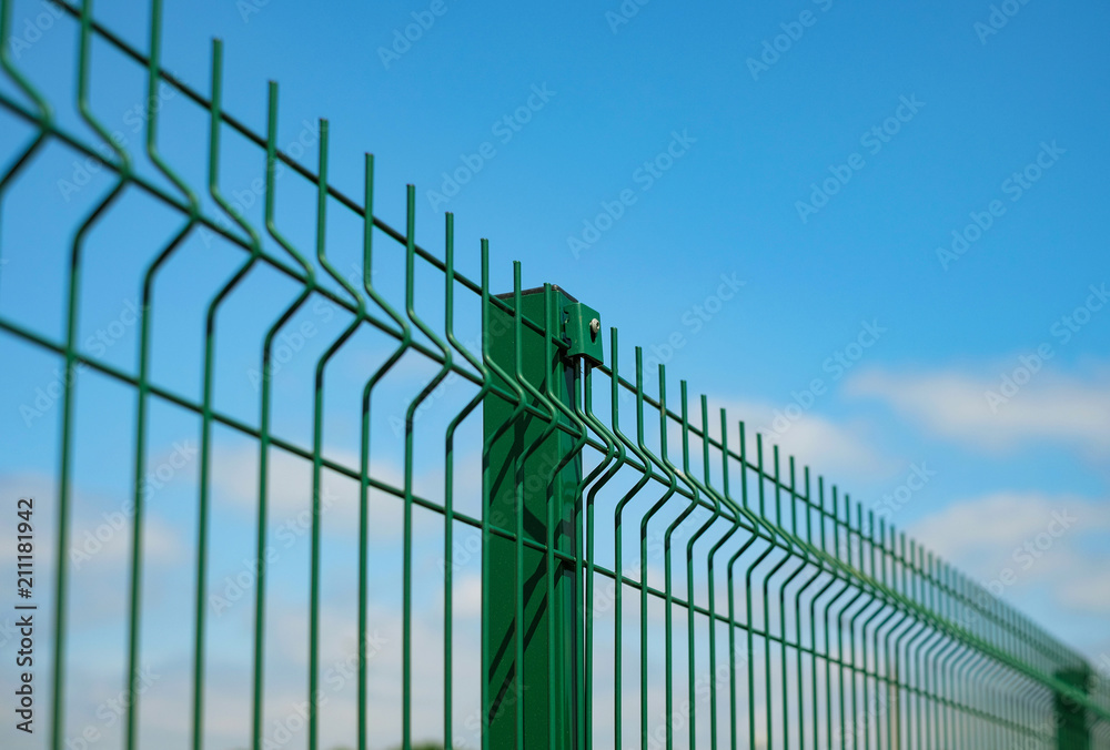 Steel grating fence made with wire on blue sky background. Sectional ...