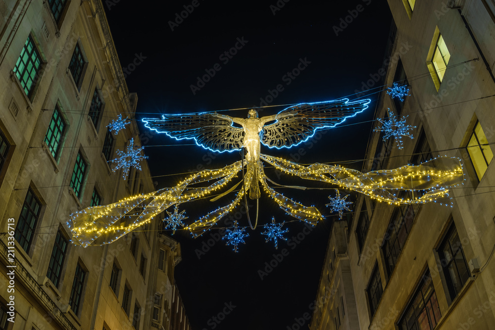 Christmas lights in the shape of a winged angel twinkle in the night ...