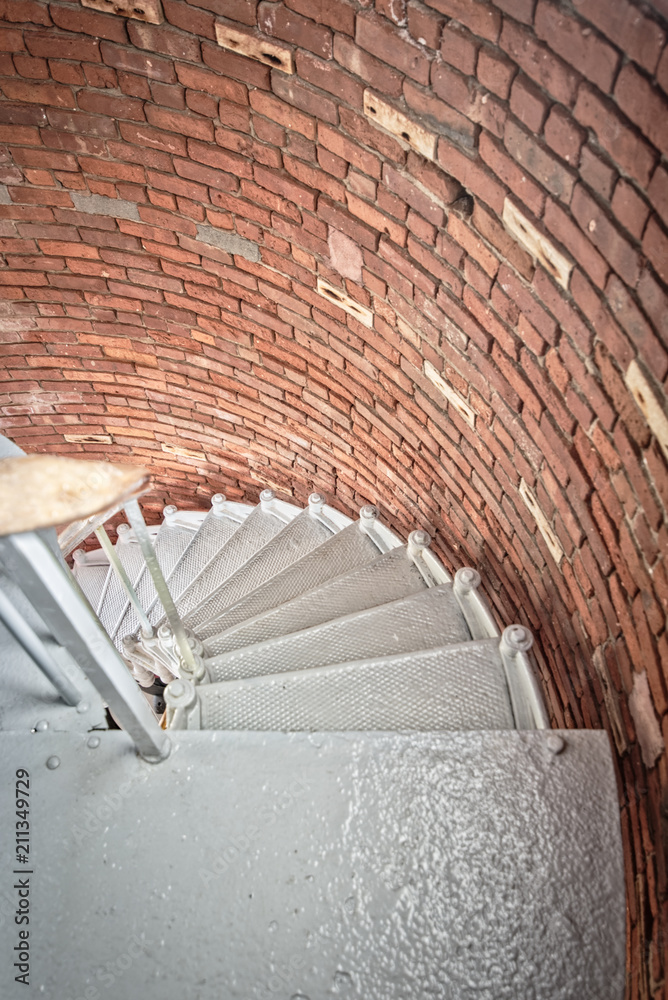 Spiral steps lead from the light room to the lower levels of a ...