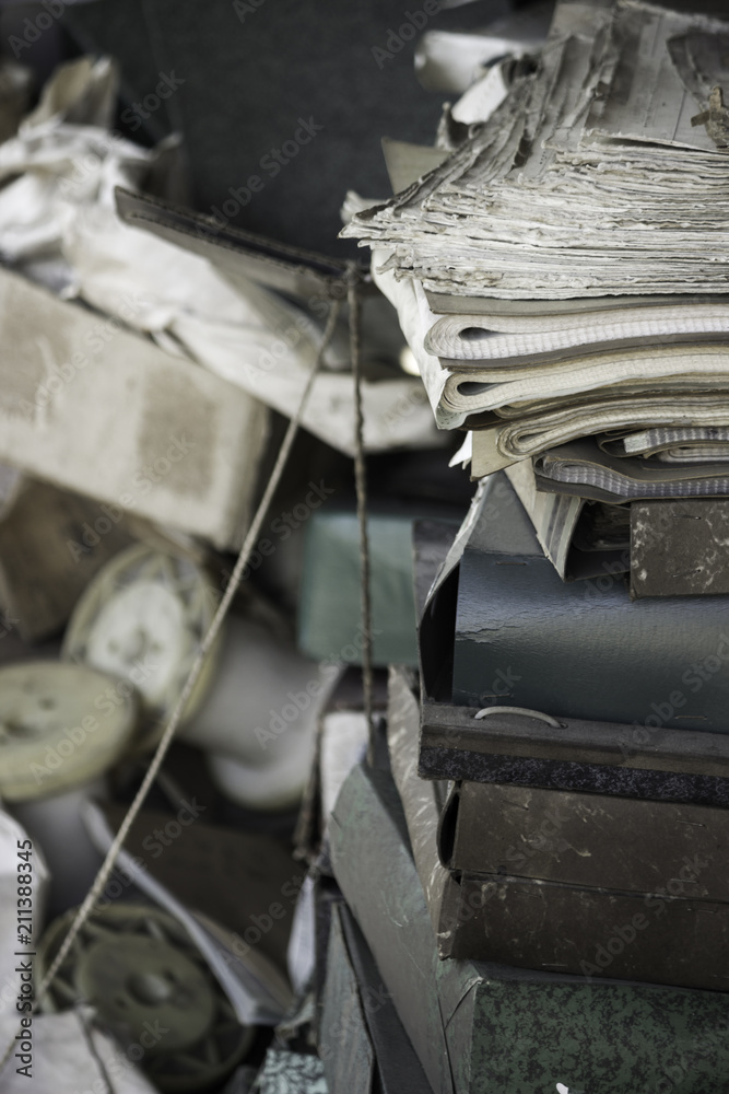 A closeup of old notebooks, documents and cardboard boxes, stacked on ...
