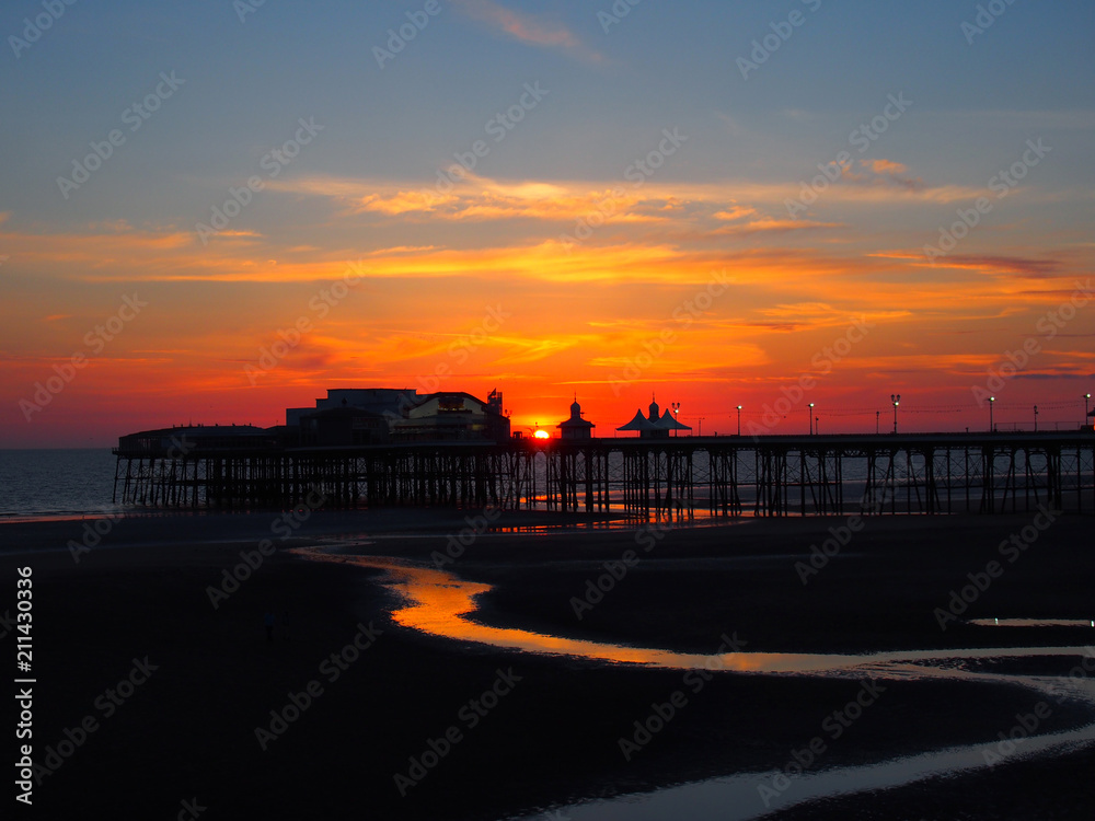 scenic view of blackpool north pier in glowing red evening light at ...