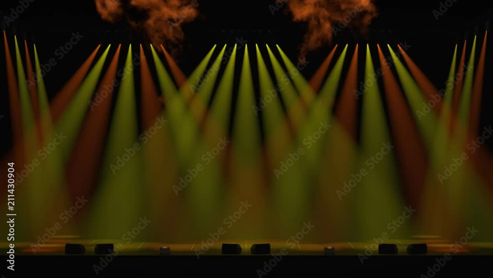 Orange and yellow spotlights down onto a stage with a fire show at ...