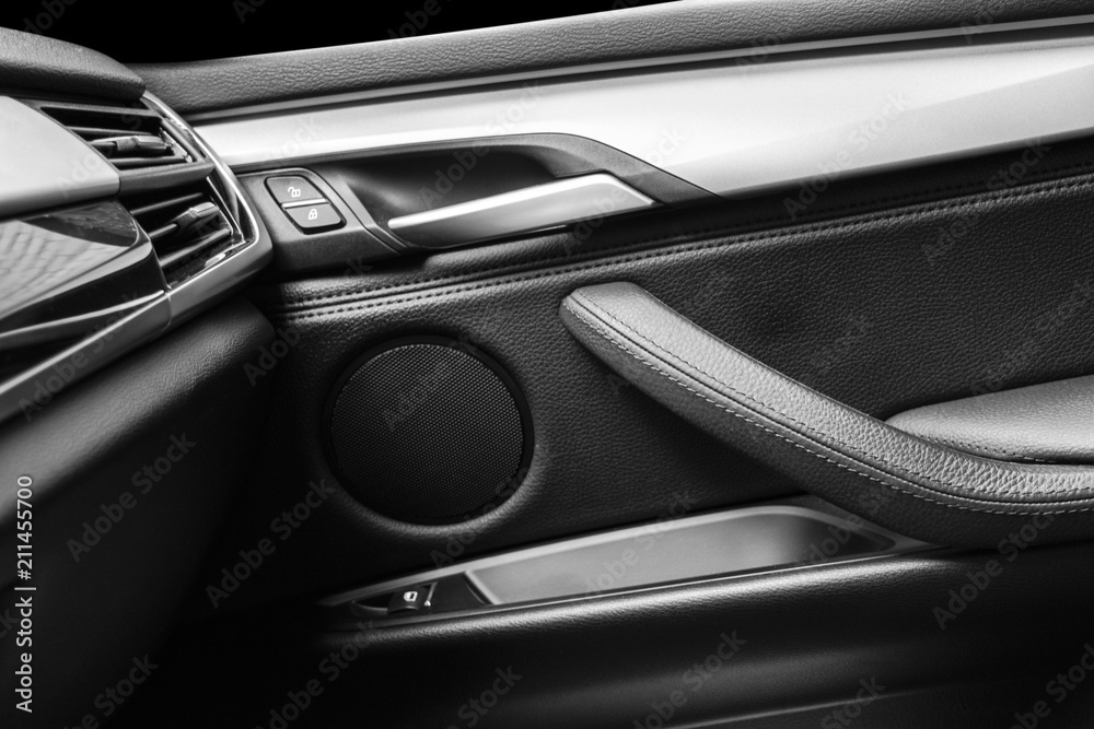 Door handle with Power window control buttons of a luxury passenger car ...